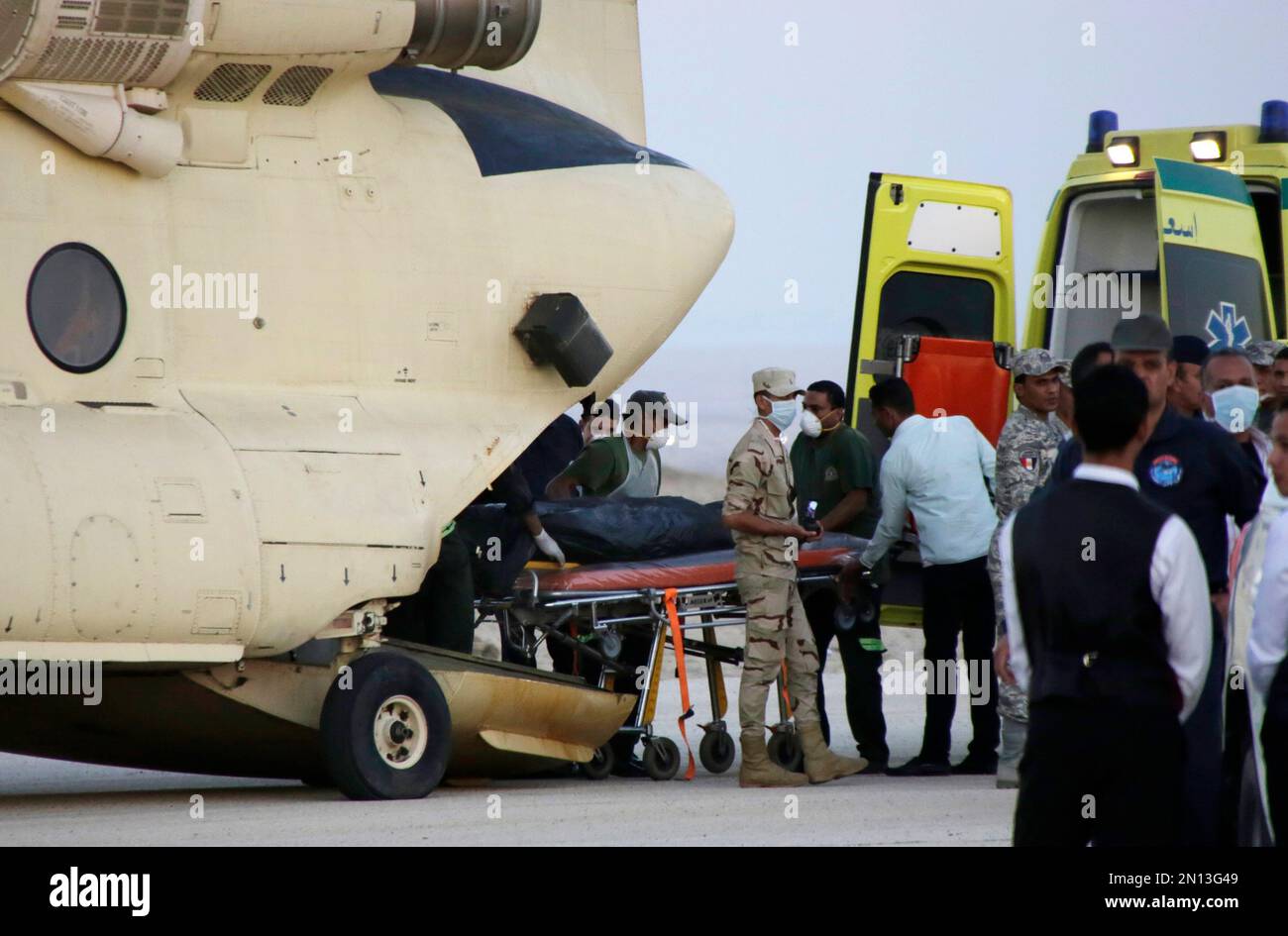 An Egtptian search and rescue crew transfers the body of a victim of a ...