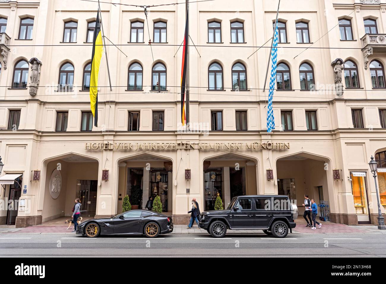 Hotel Vier Jahreszeiten Kempinski, in front of it sports car Ferrari ...