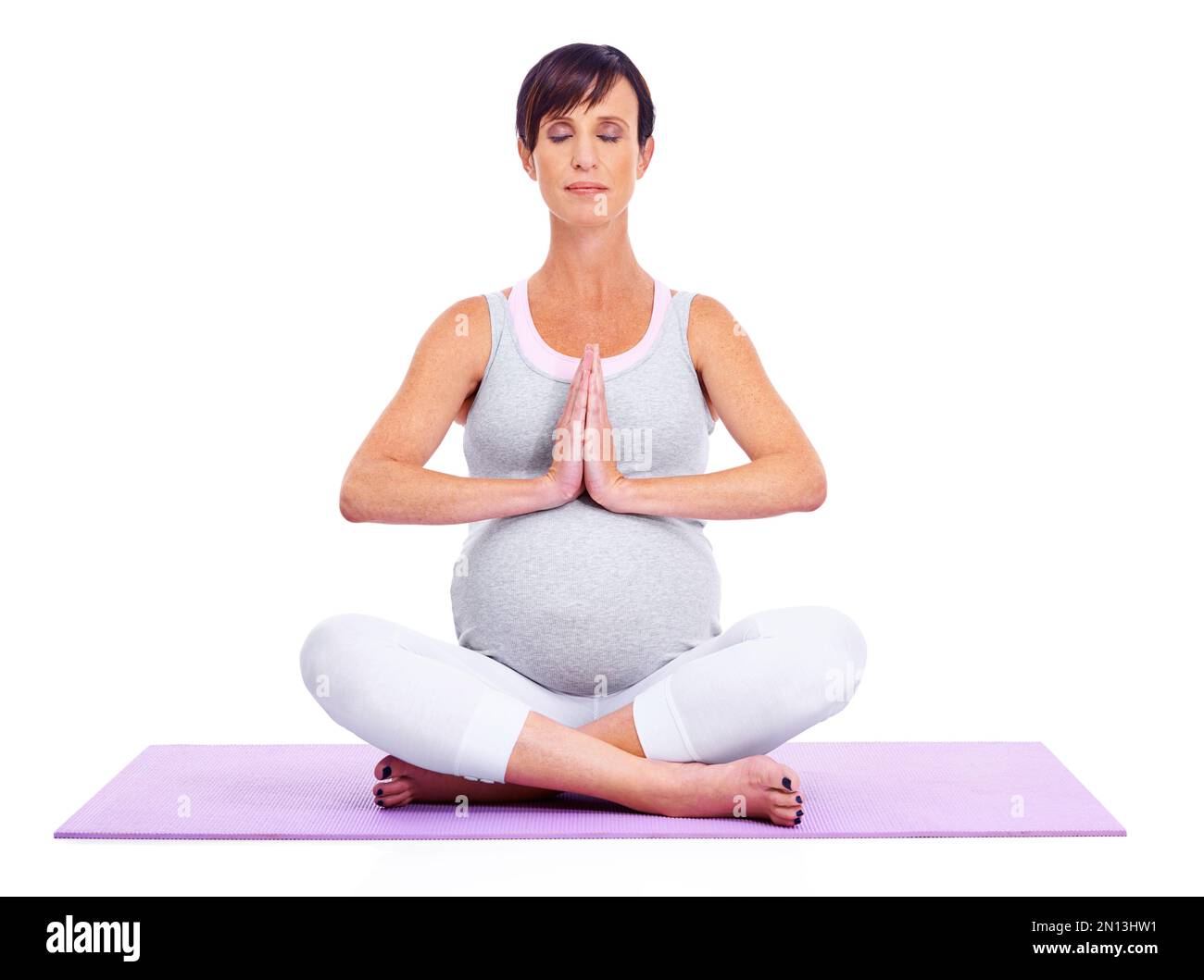Channeling inner harmony to her child. A young pregnant woman ...