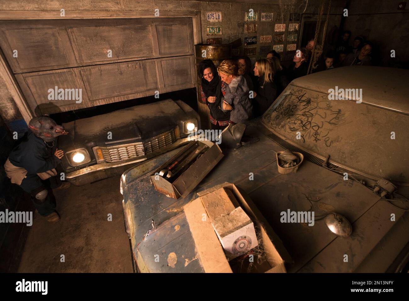 Guests freeze along the main route after an actor scares them at the ...