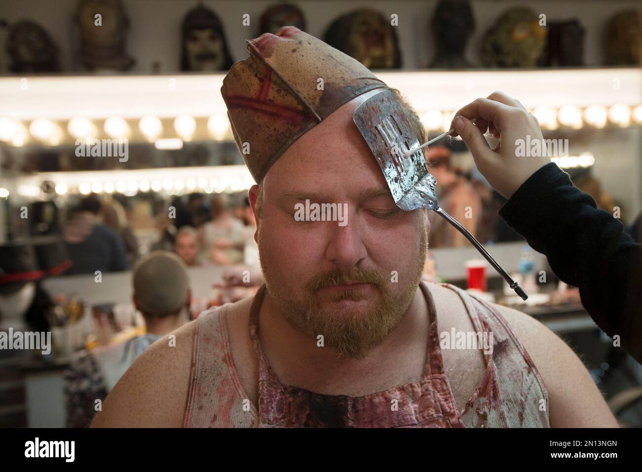 Actors Danny Brackett closes his eyes as he has a spatula glued to his ...