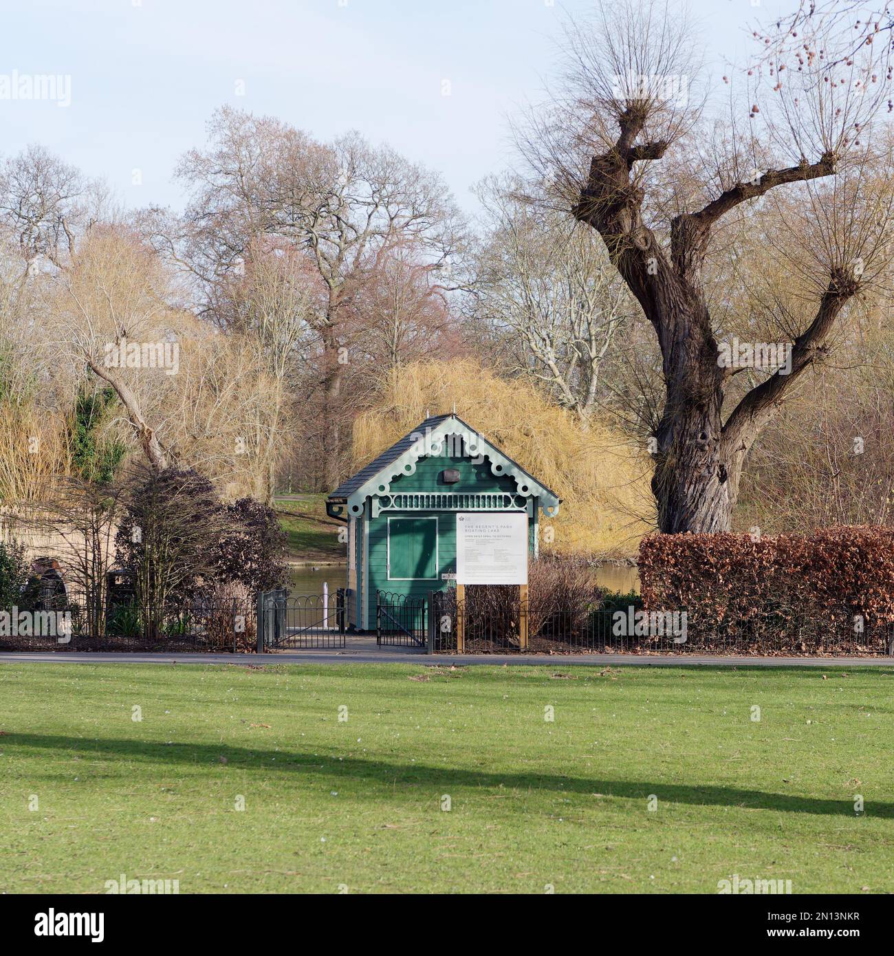 Green wooden hut surrounded by trees in Regent Park on a winters day ...