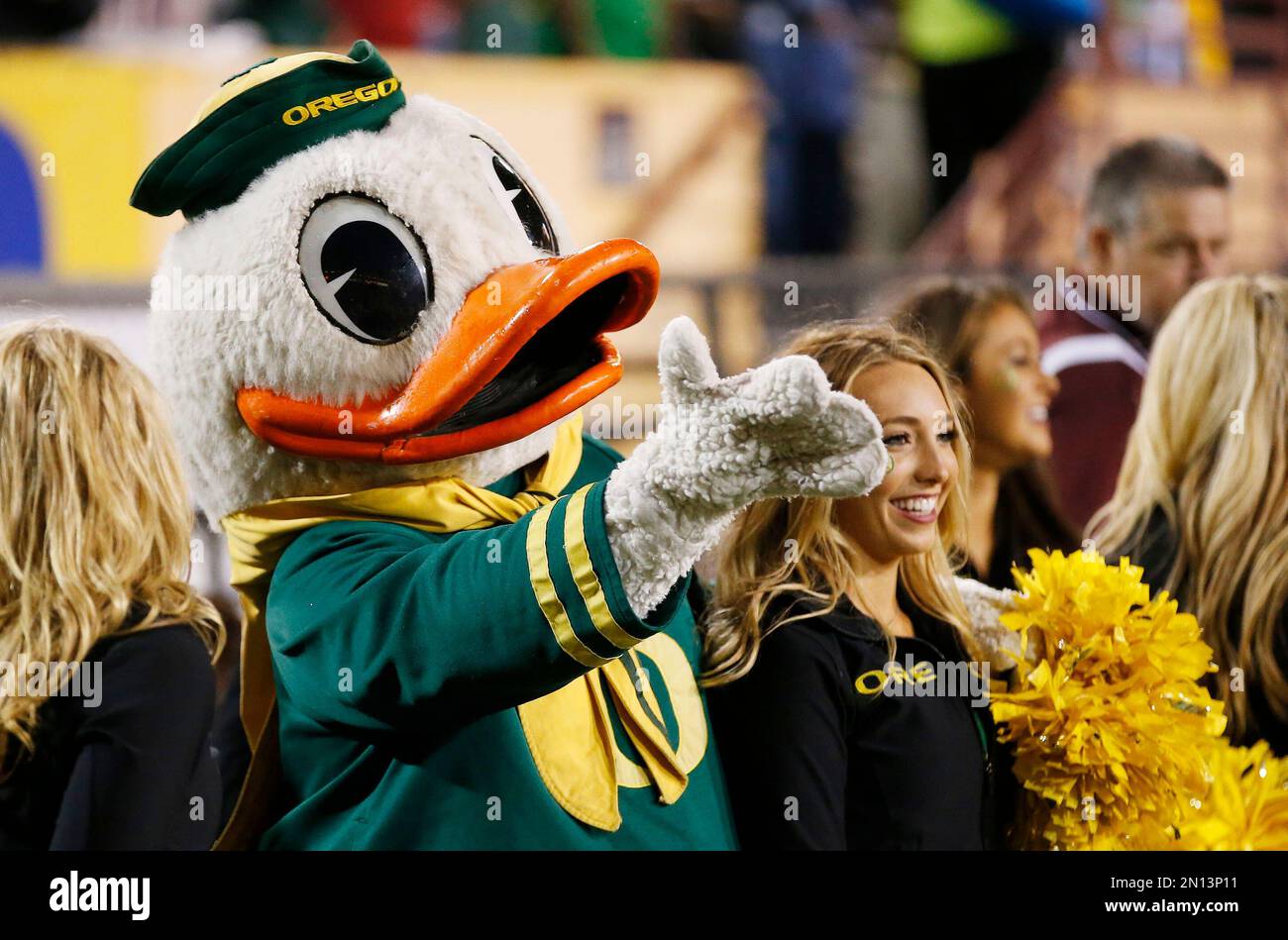 The Oregon mascot The Duck makes a cheerleader smile during the first ...