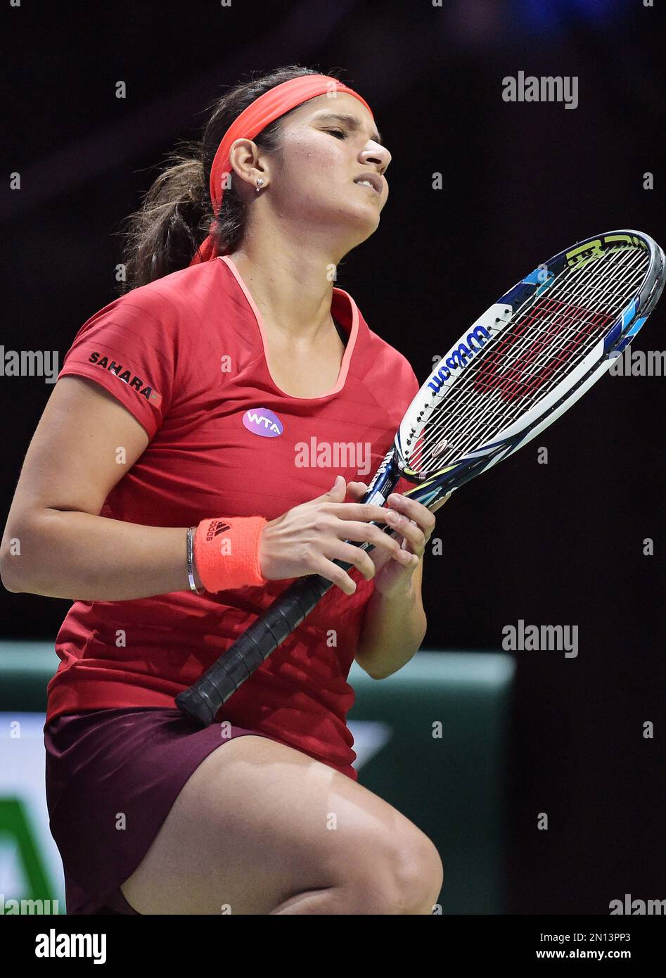 Sania Mirza of India reacts after missing a return as she and partner ...