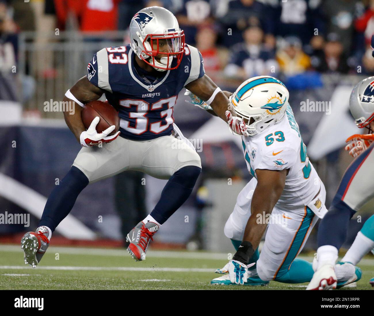 New England Patriots running back Dion Lewis (33) evades Miami Dolphins ...