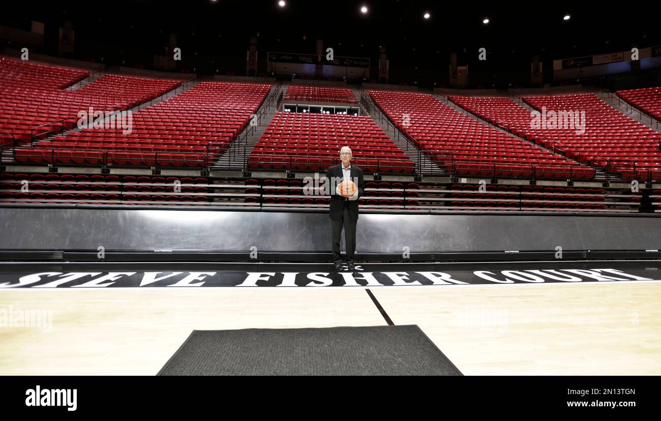 San Diego State basketball coach Steve Fisher poses along the sideline ...