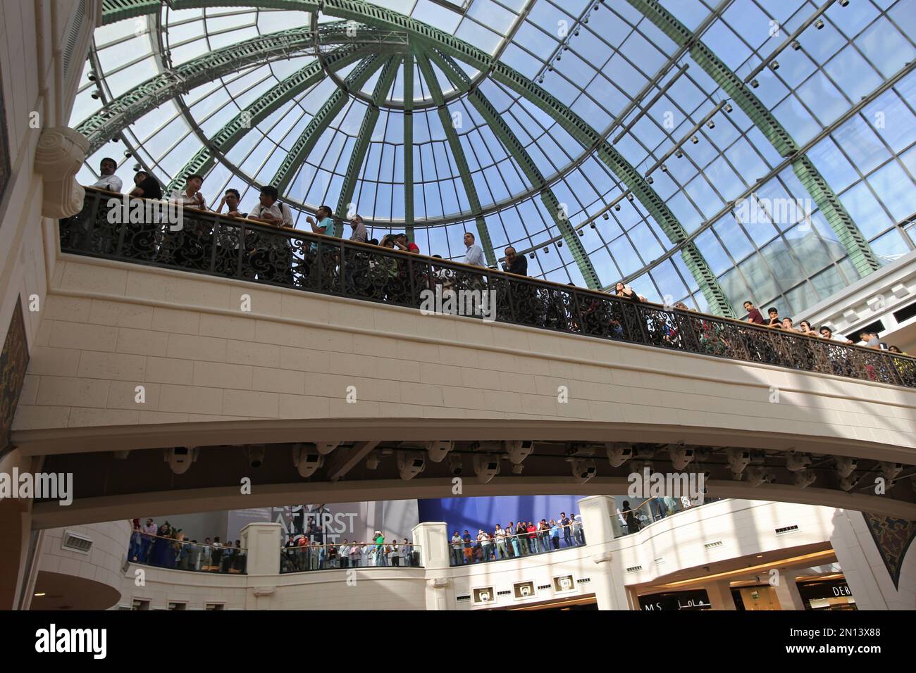 People stand in line for the grand opening of the Apple Store at a ...