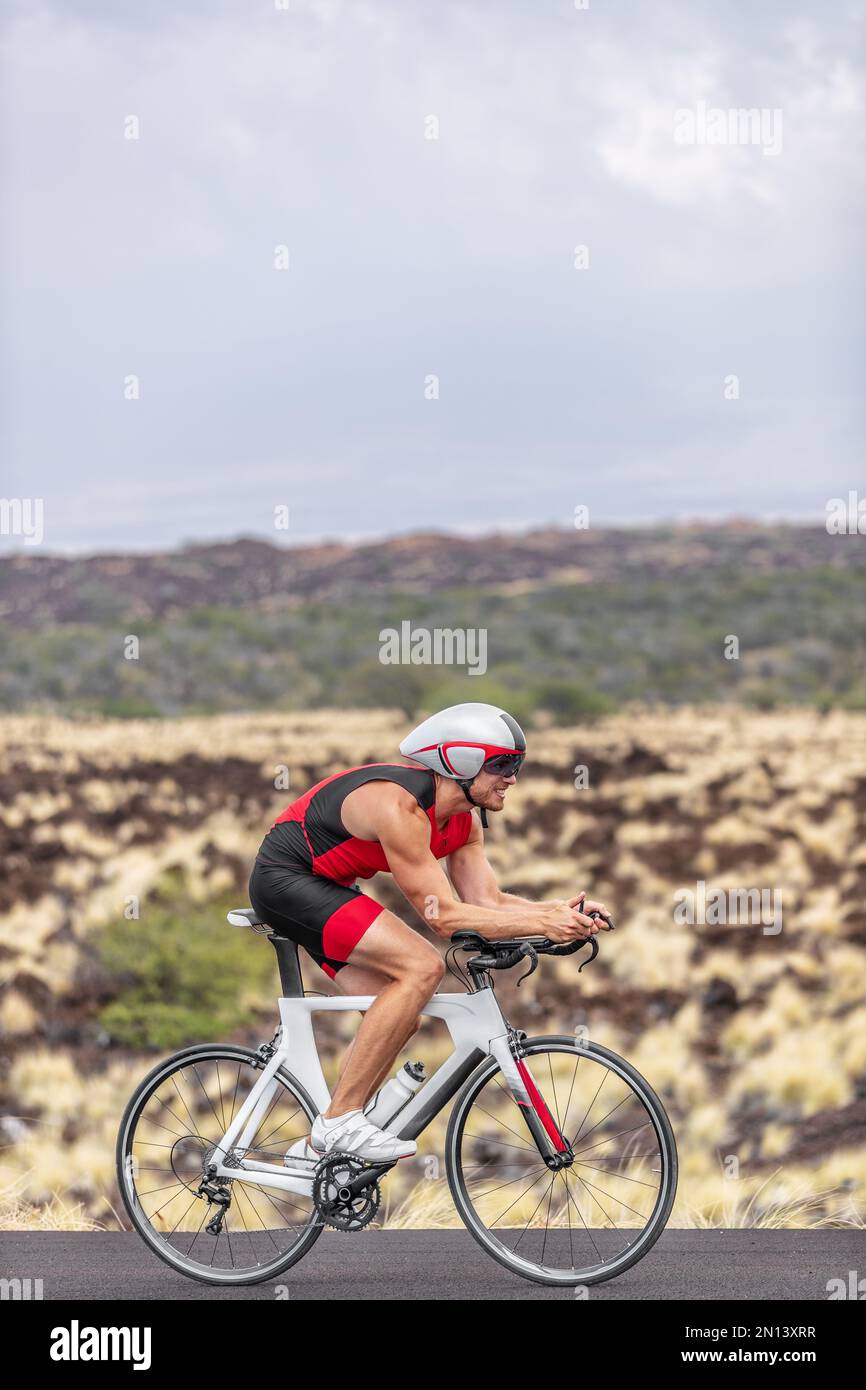 Triathlon time trial competition triathlete man cyclist riding road ...