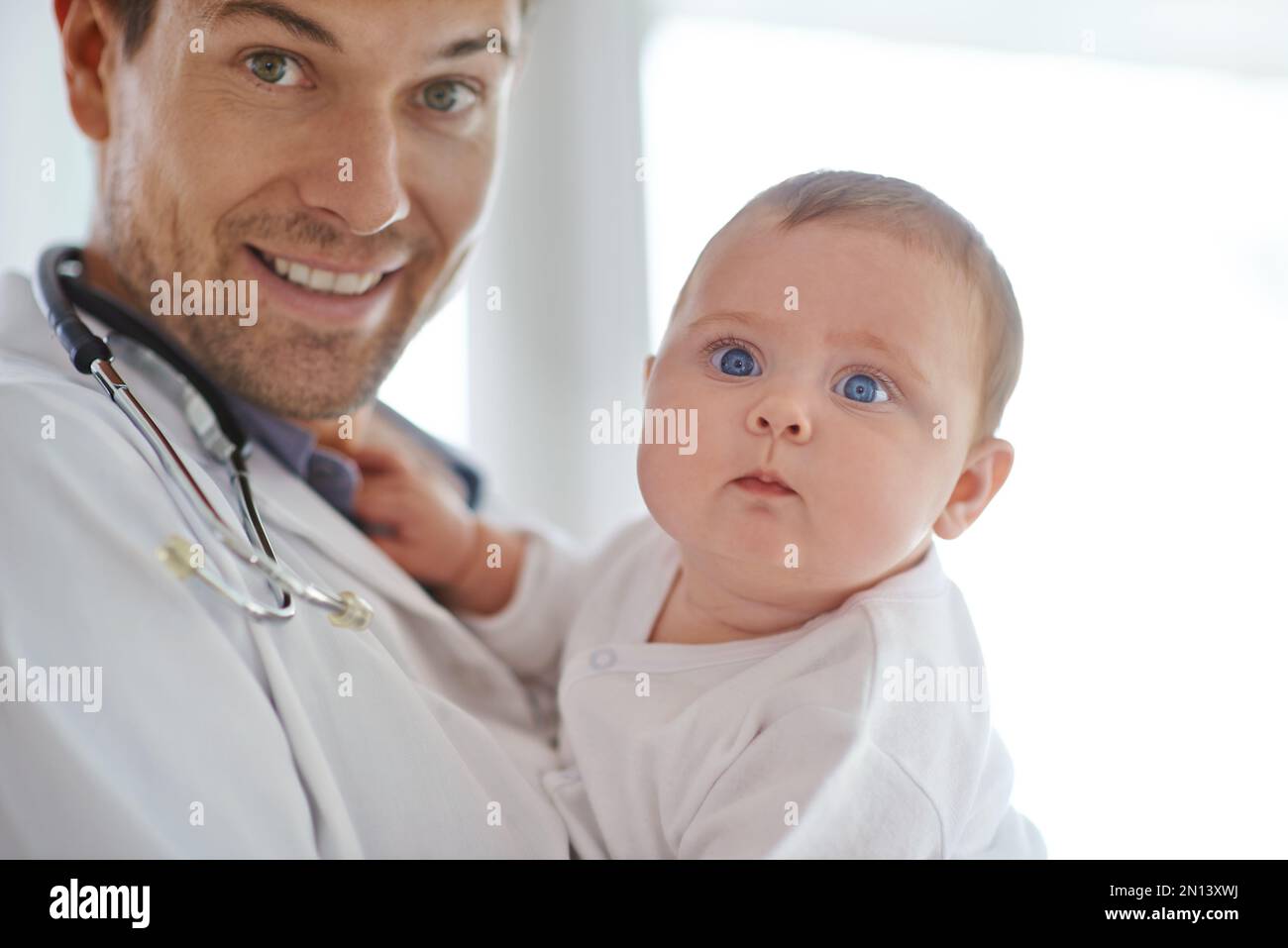 Precious little life. Portrait of a handsome male doctor holding an ...