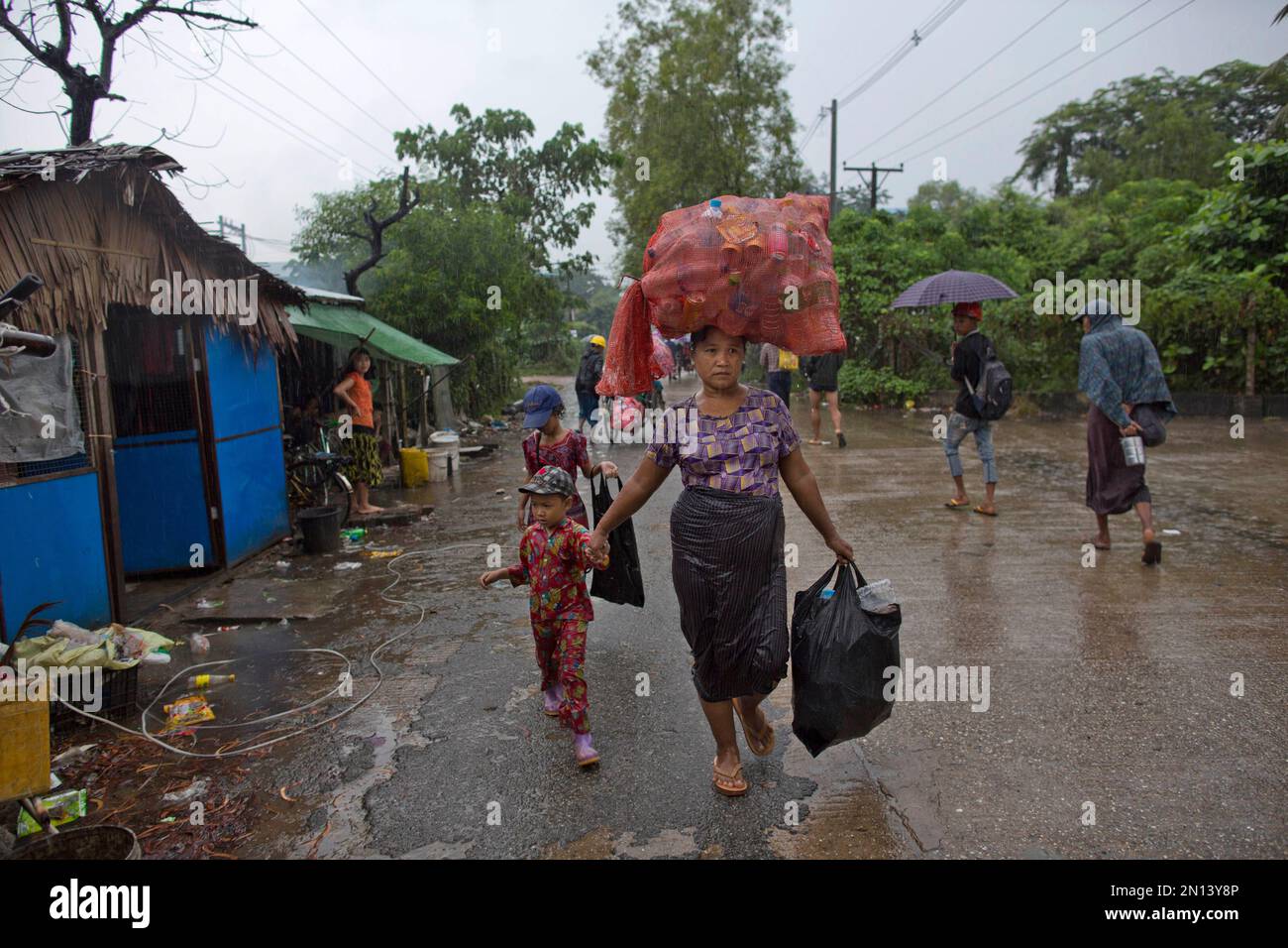 In this Oct. 6 , 2015 photo, a woman balances a bag of recyclables that ...