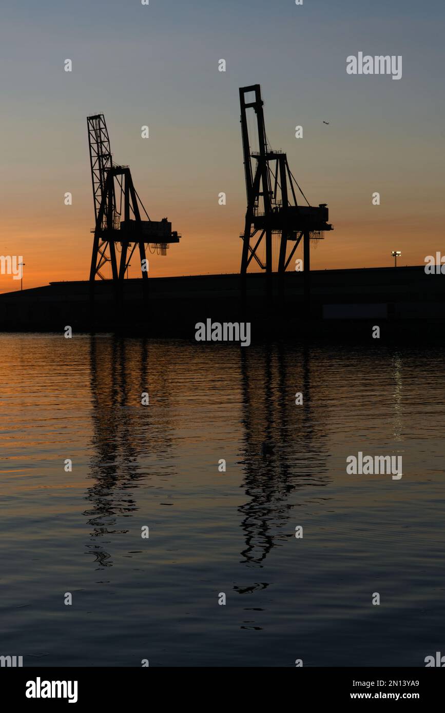 Two container cranes during sunrise in Warm Water Cove Park, San ...