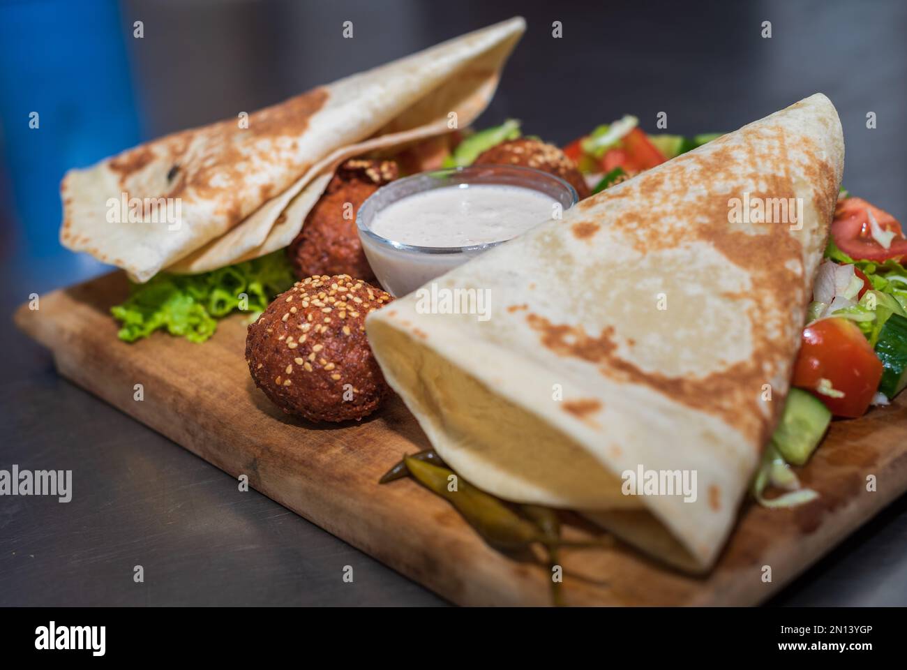 Presenting the middle eastern Lebanese dish Falafel on a wooden plate ...