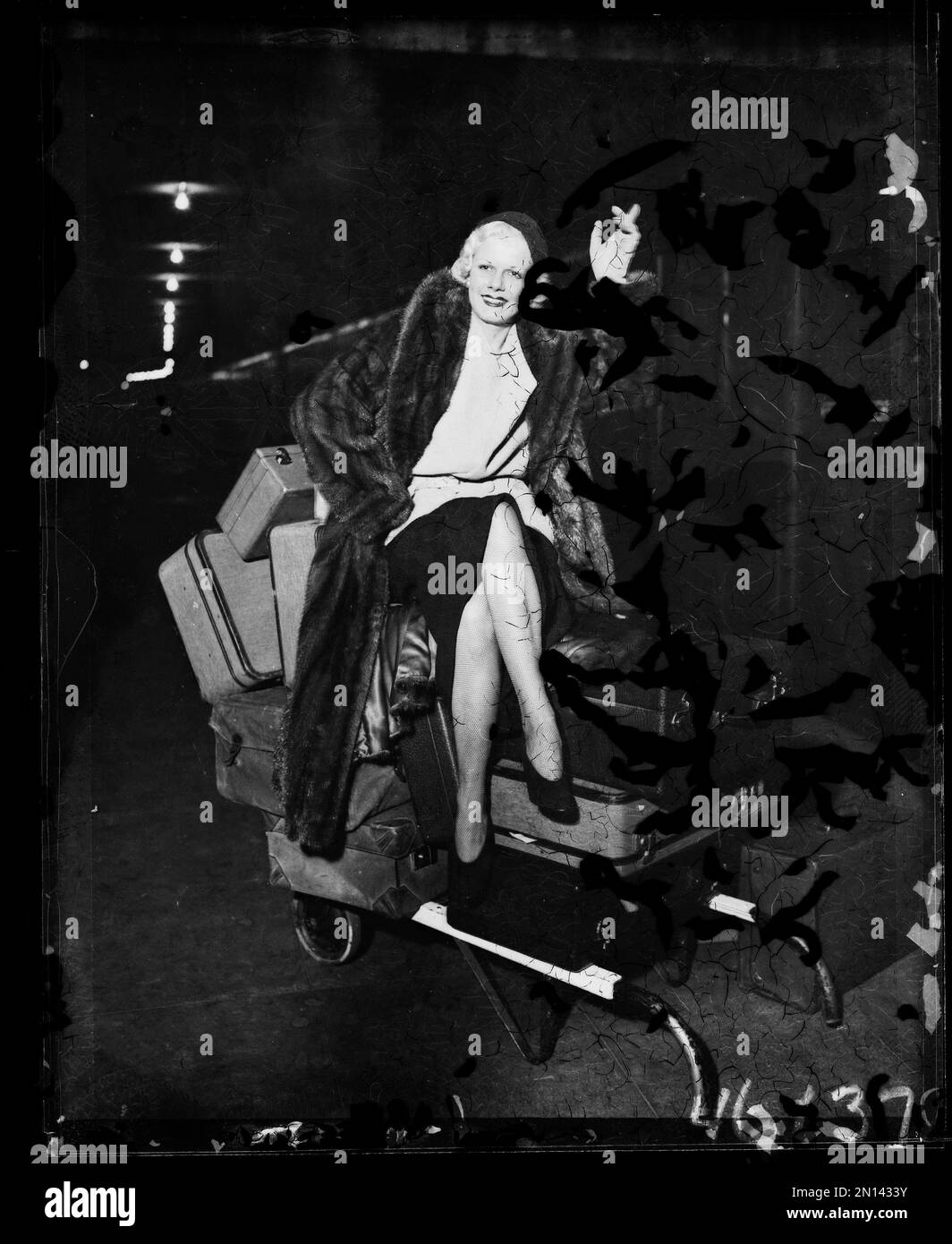 Actress Jean Harlow, the platinum blonde film beauty, greets a battery ...