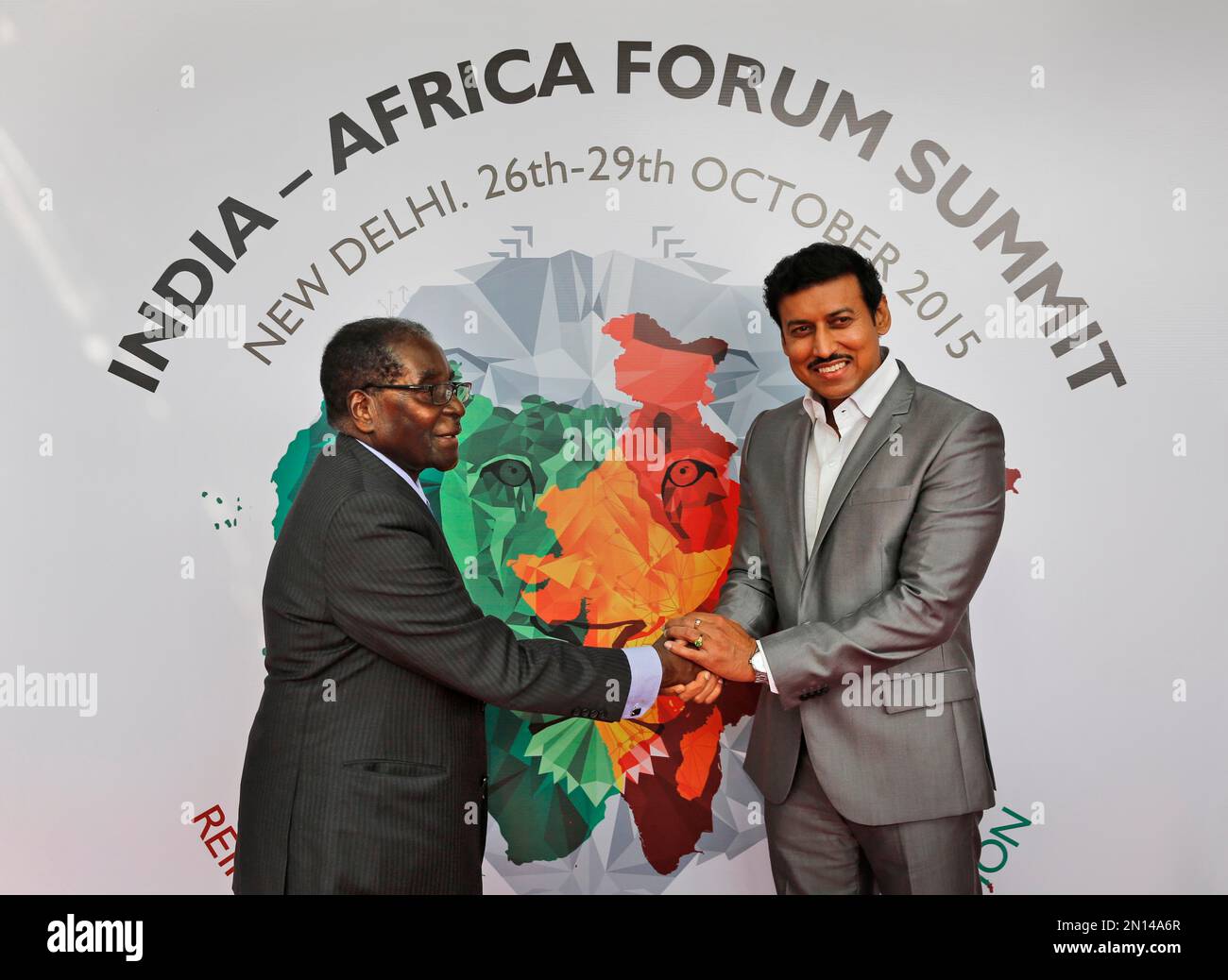 Zimbabwe's President Robert Mugabe, left, is received by Indian junior ...