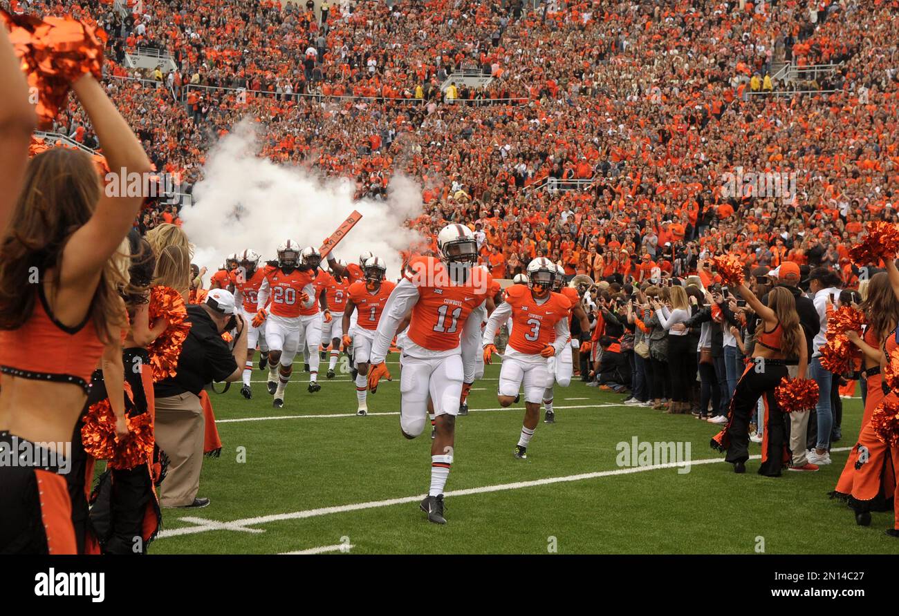 Oklahoma State safety Tre Roberts (11) leads his team onto the field at ...
