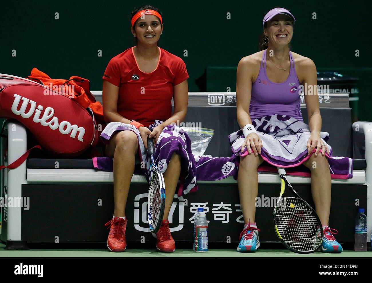 Sania Mirza of India, left, sits with partner Martina Hingis of ...