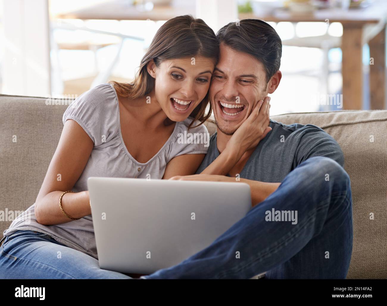 OMG Thats so funny. An affectionate young couple laughing together ...