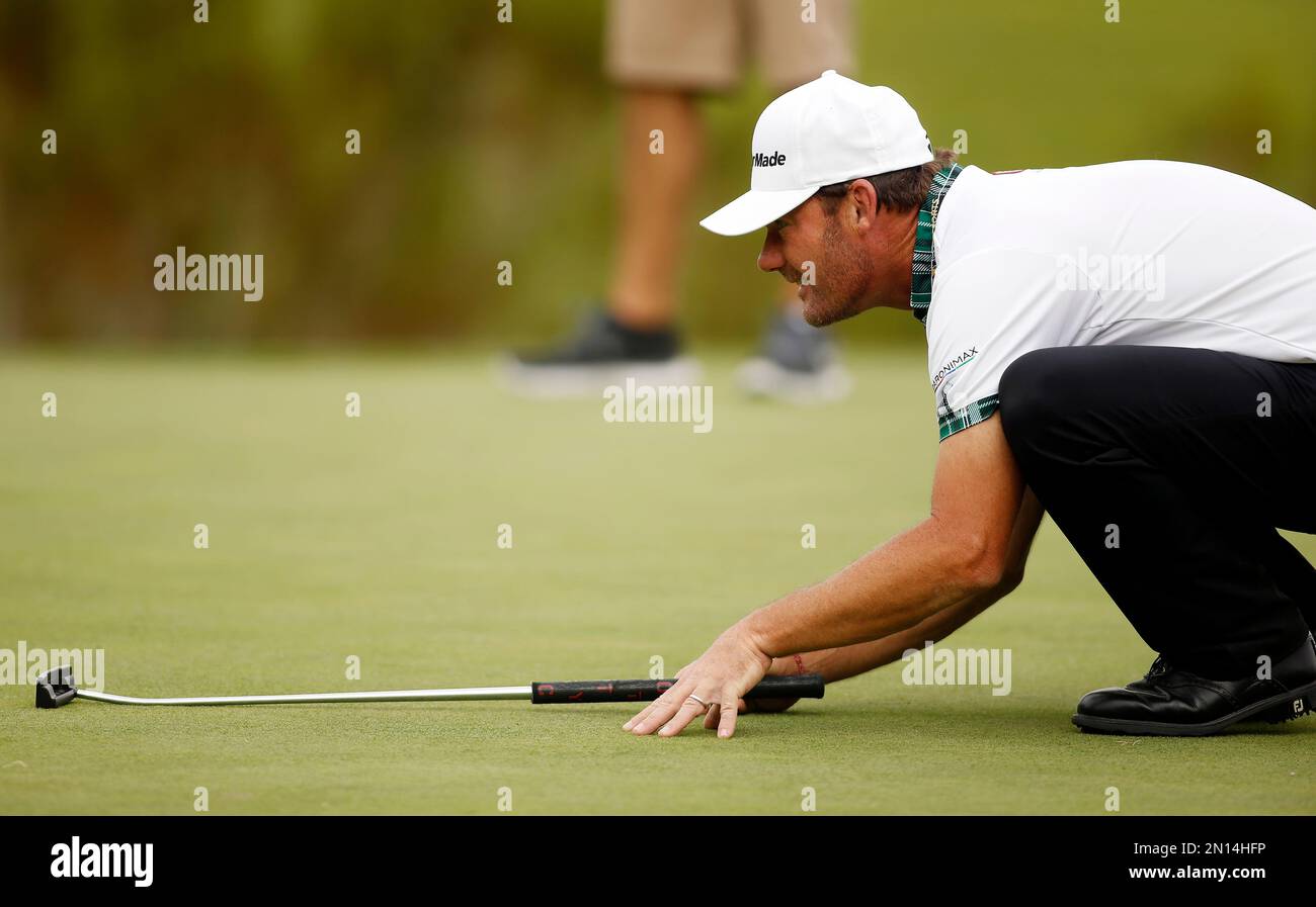 Alex Cejka, of Germany, lines up a putt on the fourth hole during the ...