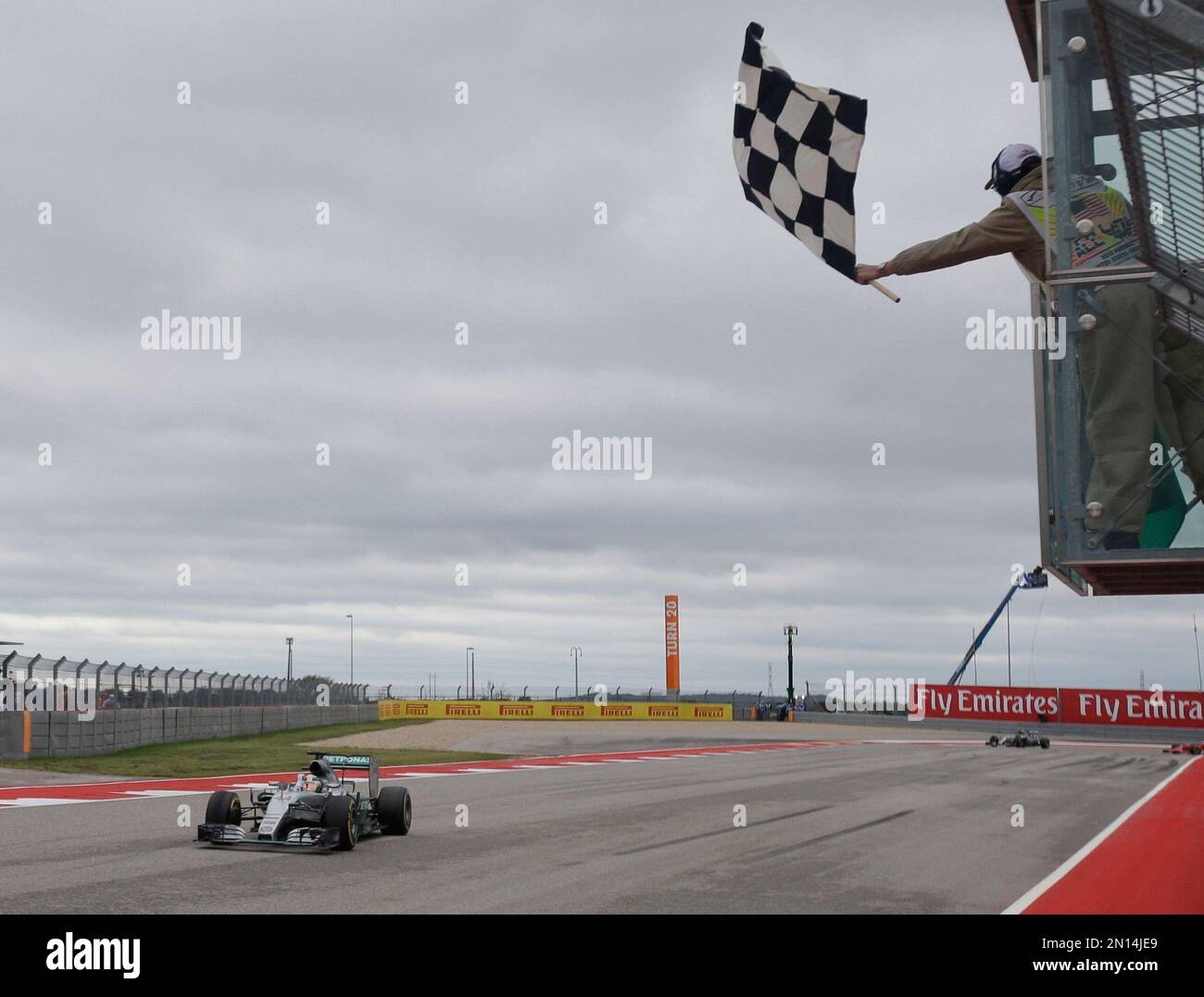 Mercedes driver Lewis Hamilton, of Britain, crosses the finish line to ...