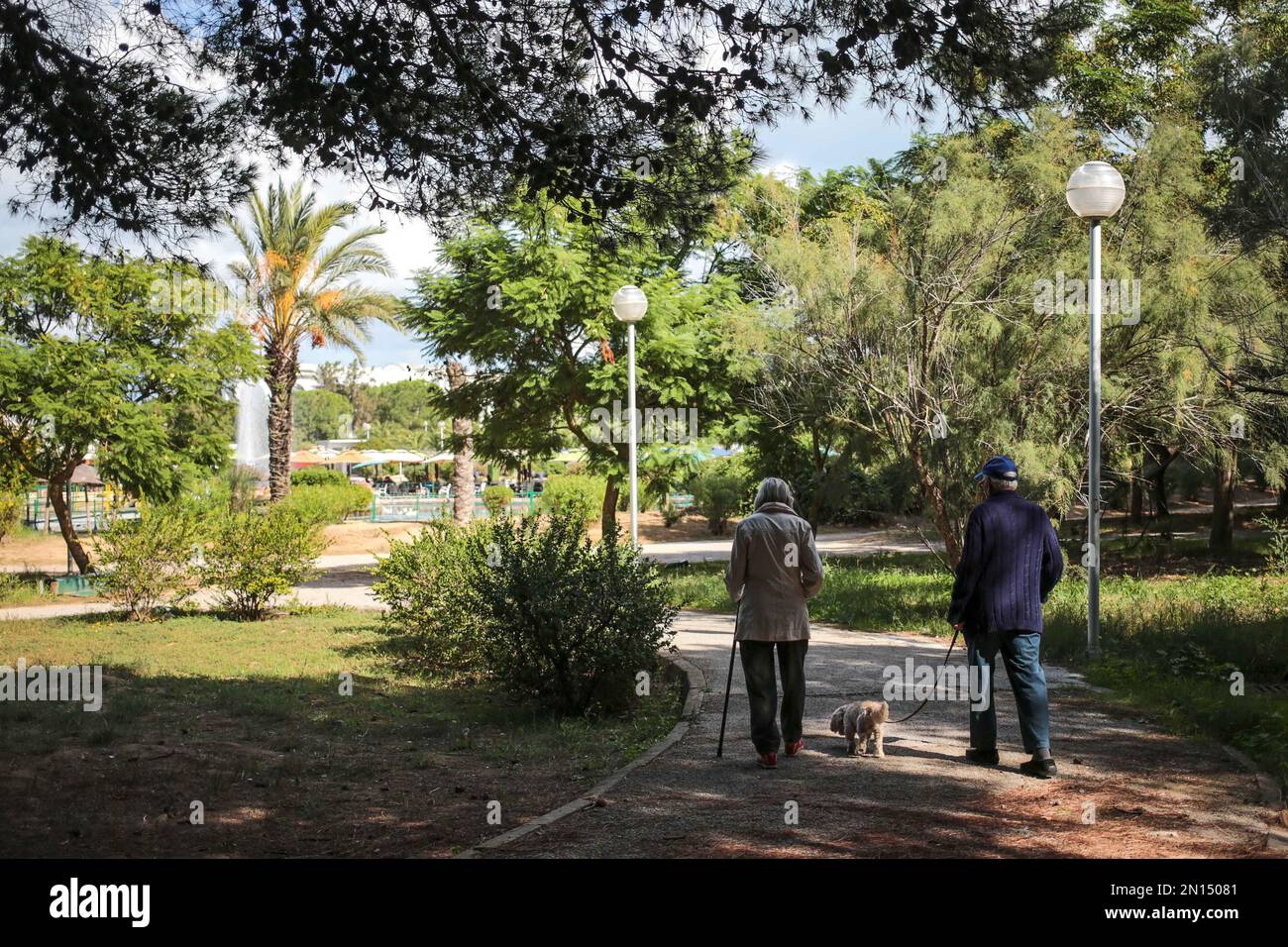 An elderly couple walk their dog at the Belvedere Park in Tunis ...