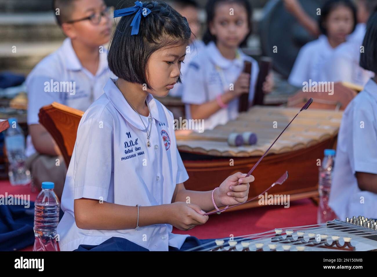 Thai school children during an opren-air performance of traditional ...