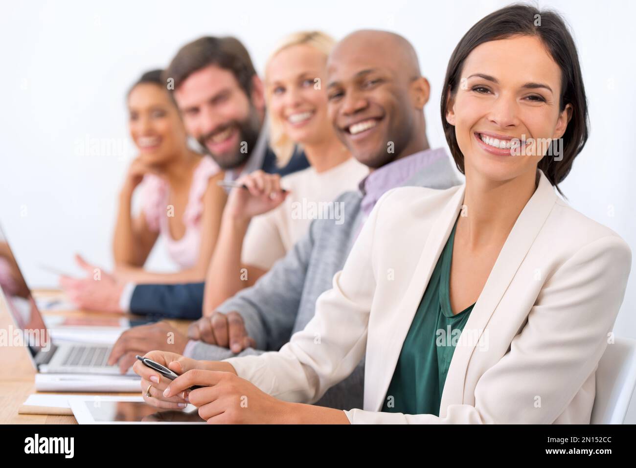They love their job. A group of business people sitting in a row ...