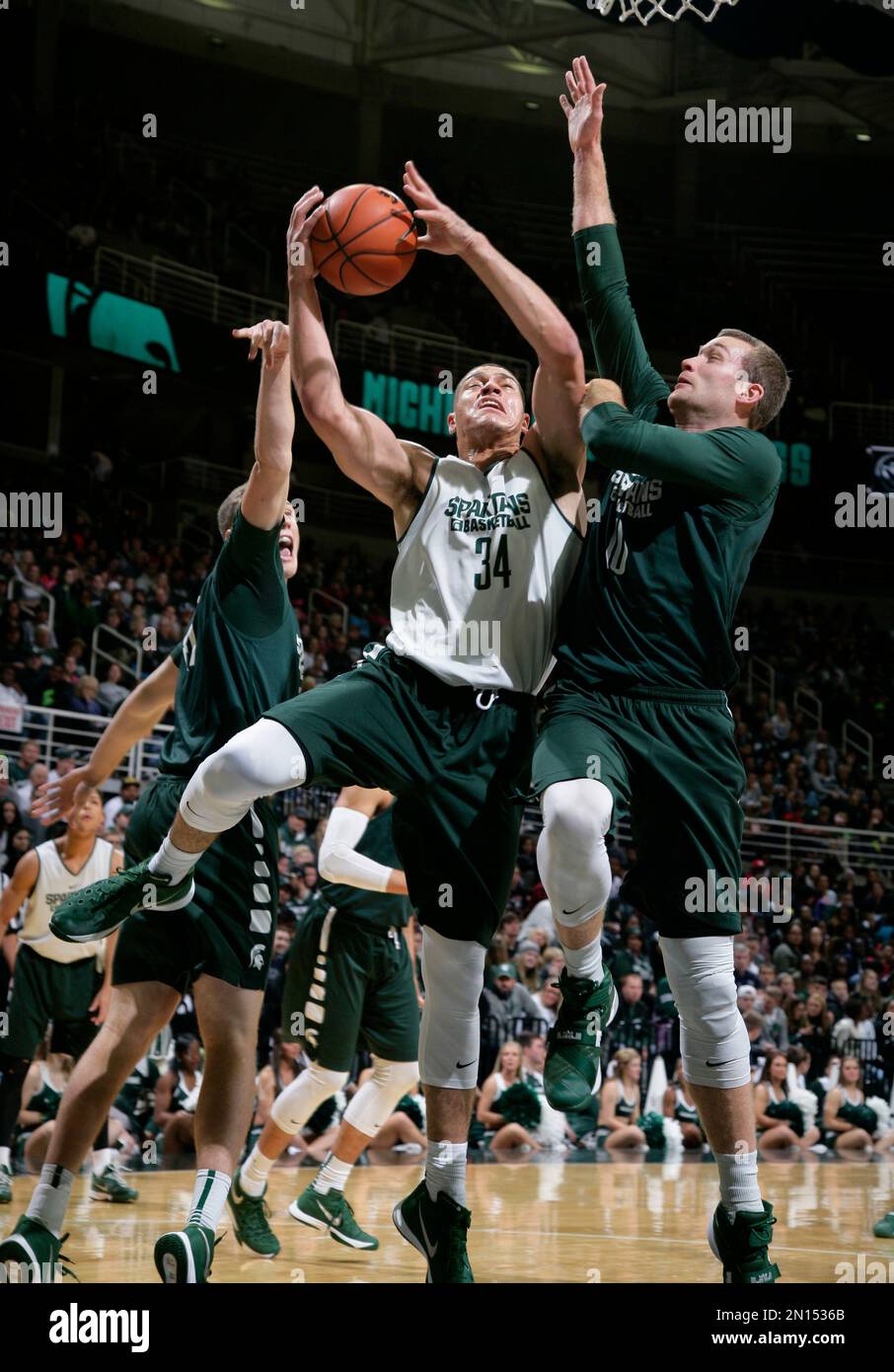 Michigan State's Gavin Schilling (34) shoots against Matt Costello ...