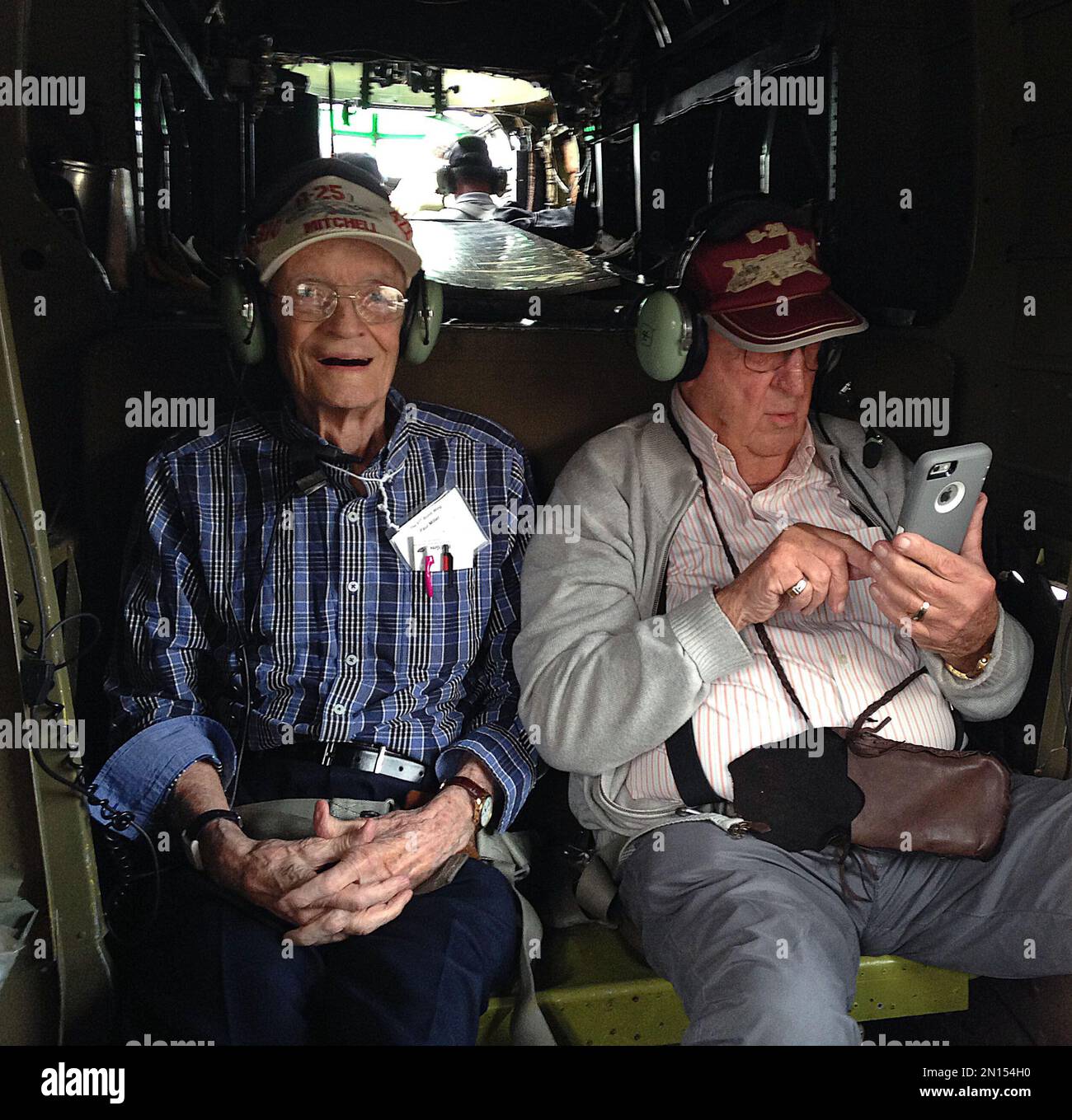 World War II veteran Martin Biener, 93, right, reviews his photos on ...