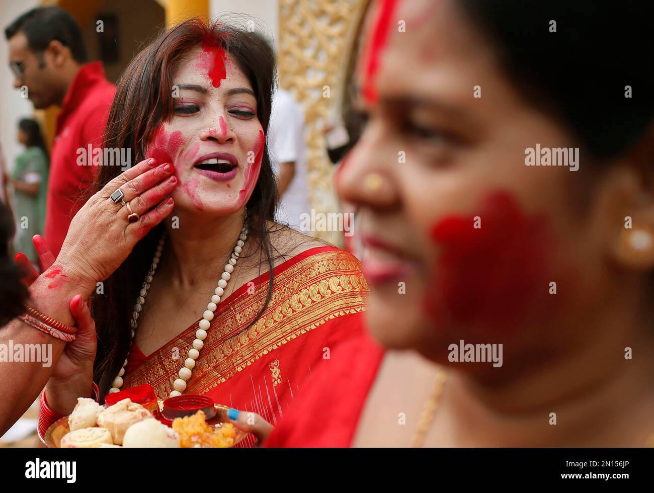 Bangladeshi Hindu devotees apply vermillion powder on each other's face ...