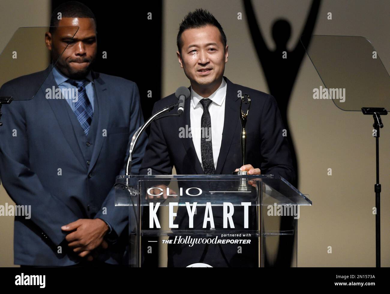 Anthony Anderson, looking on from left, as Calvin Chu, Syfy, accepts ...