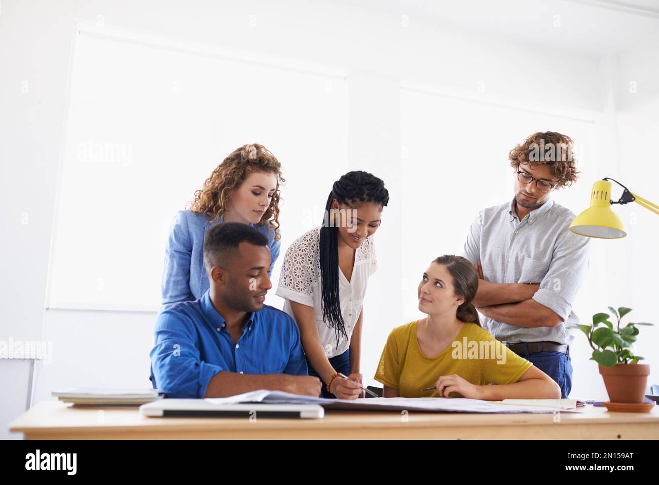 Teamwork always gets the job done. A group of young coworkers ...