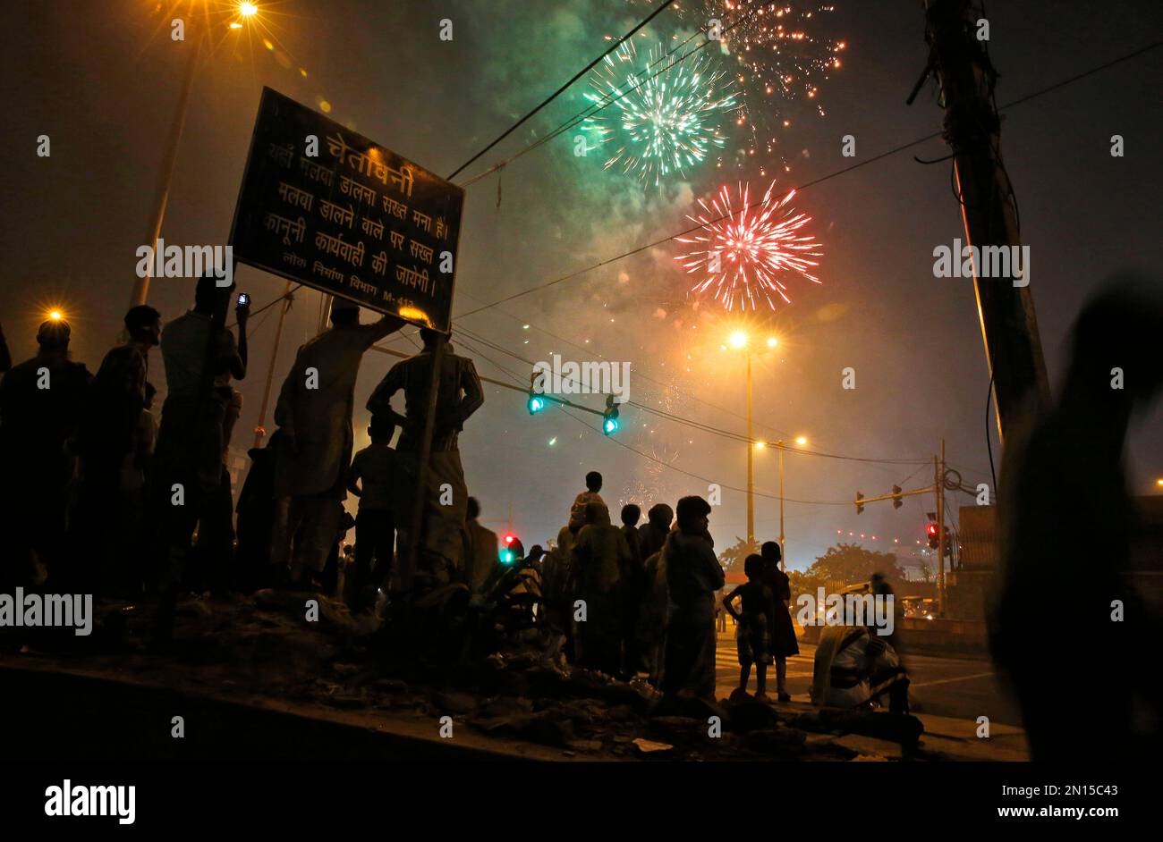 Indians watch fireworks during the burning of an effigy of the ten ...