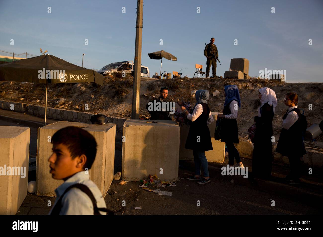 Israeli border police check Palestinian's identification cards at a ...