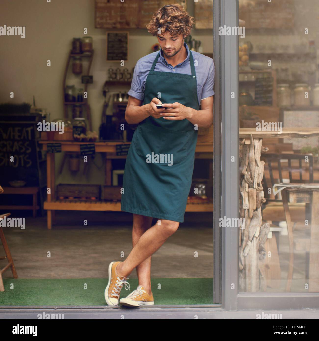 Sending texts to his customers thanking them for their patronage. young ...