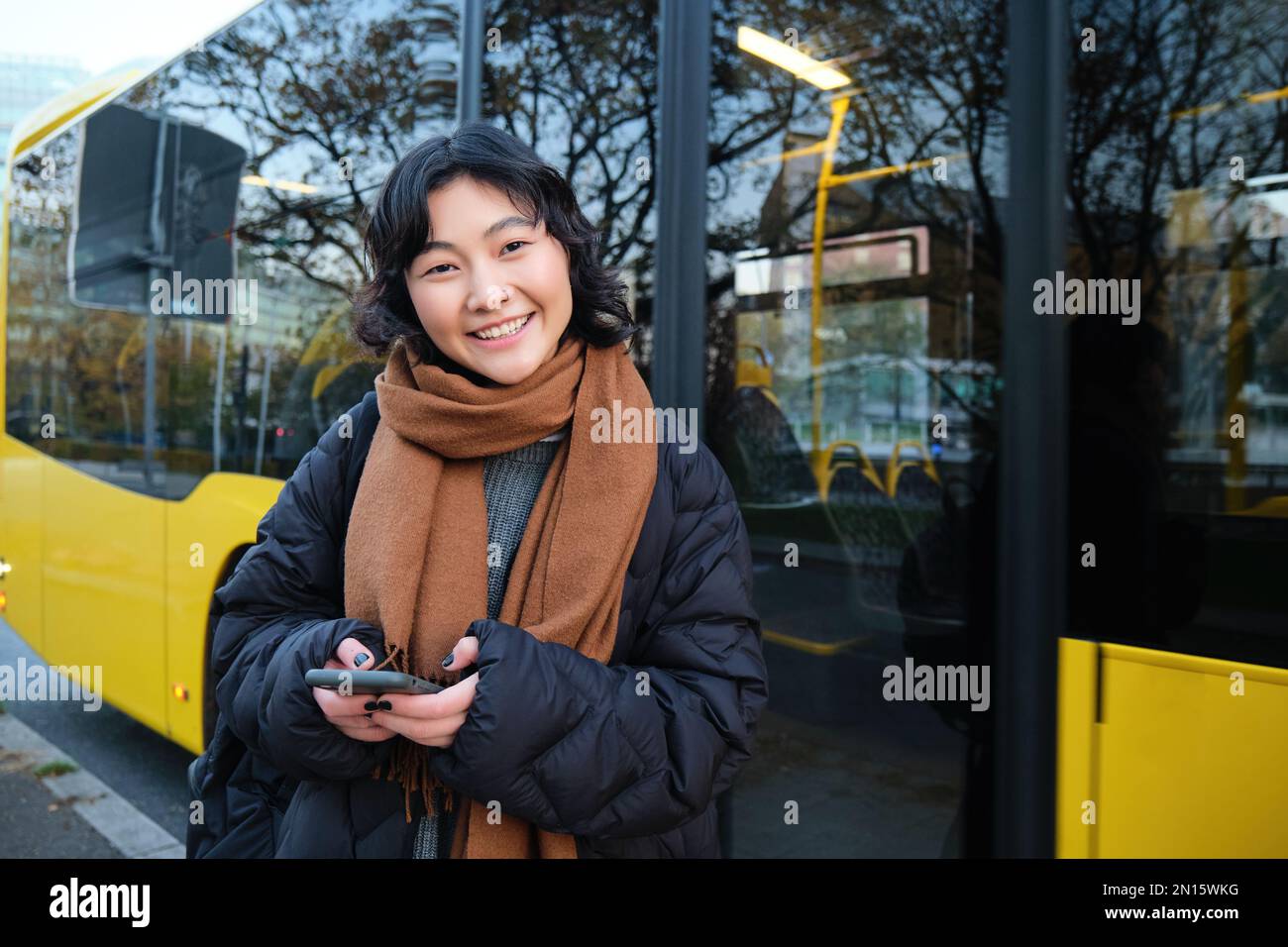Portrait of korean girl buying ticket for public transport online ...