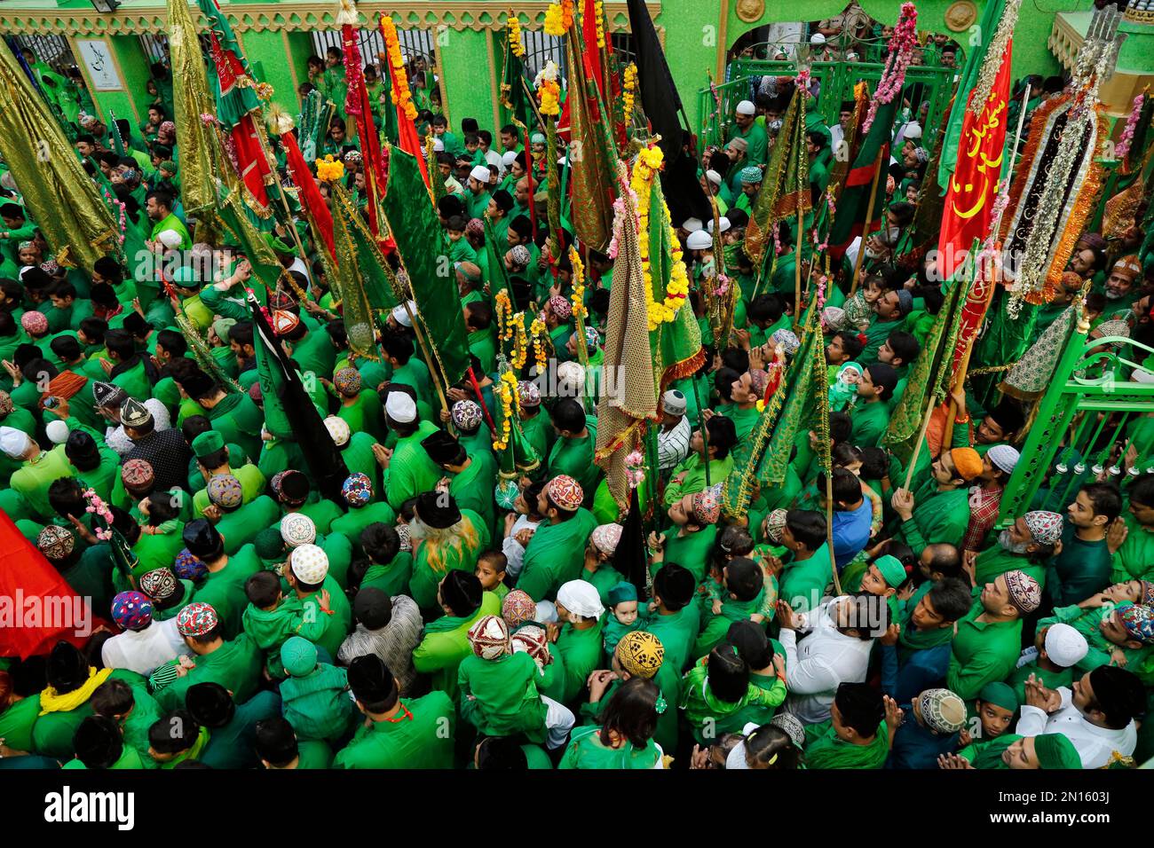 Indian Muslims participate in a procession of flags in memory of Abbas ...