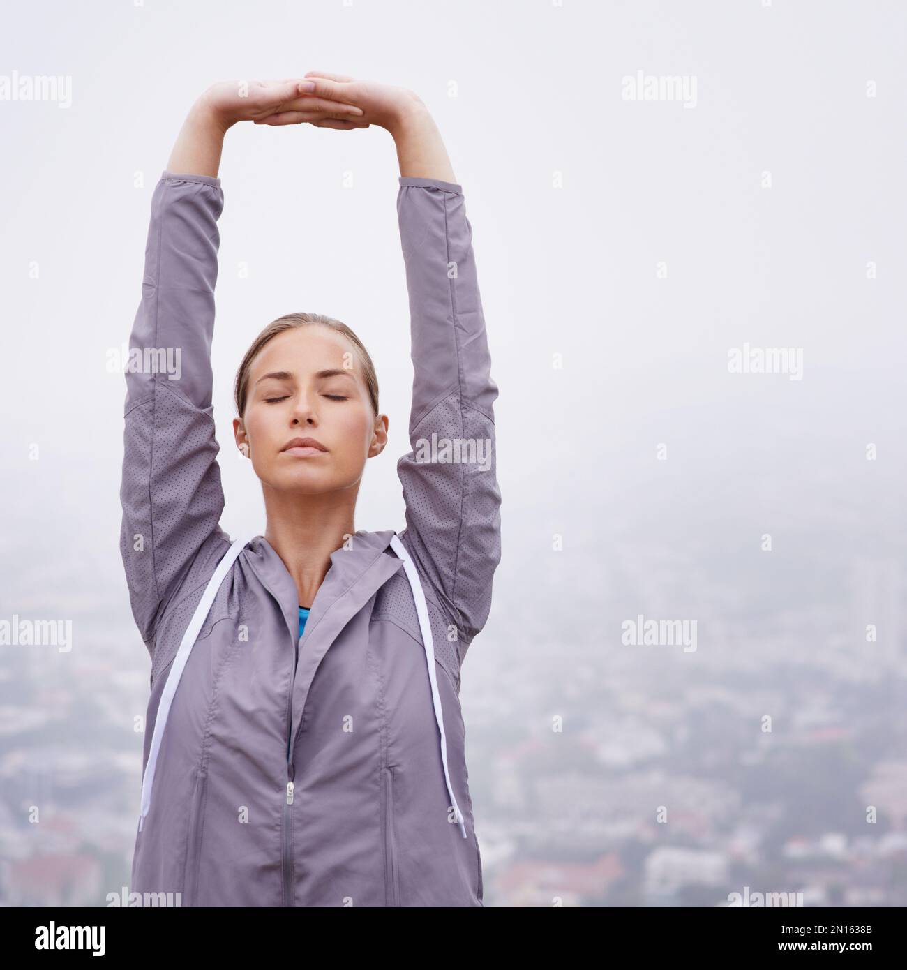 Getting ready for her run. a young woman getting ready for a run by ...