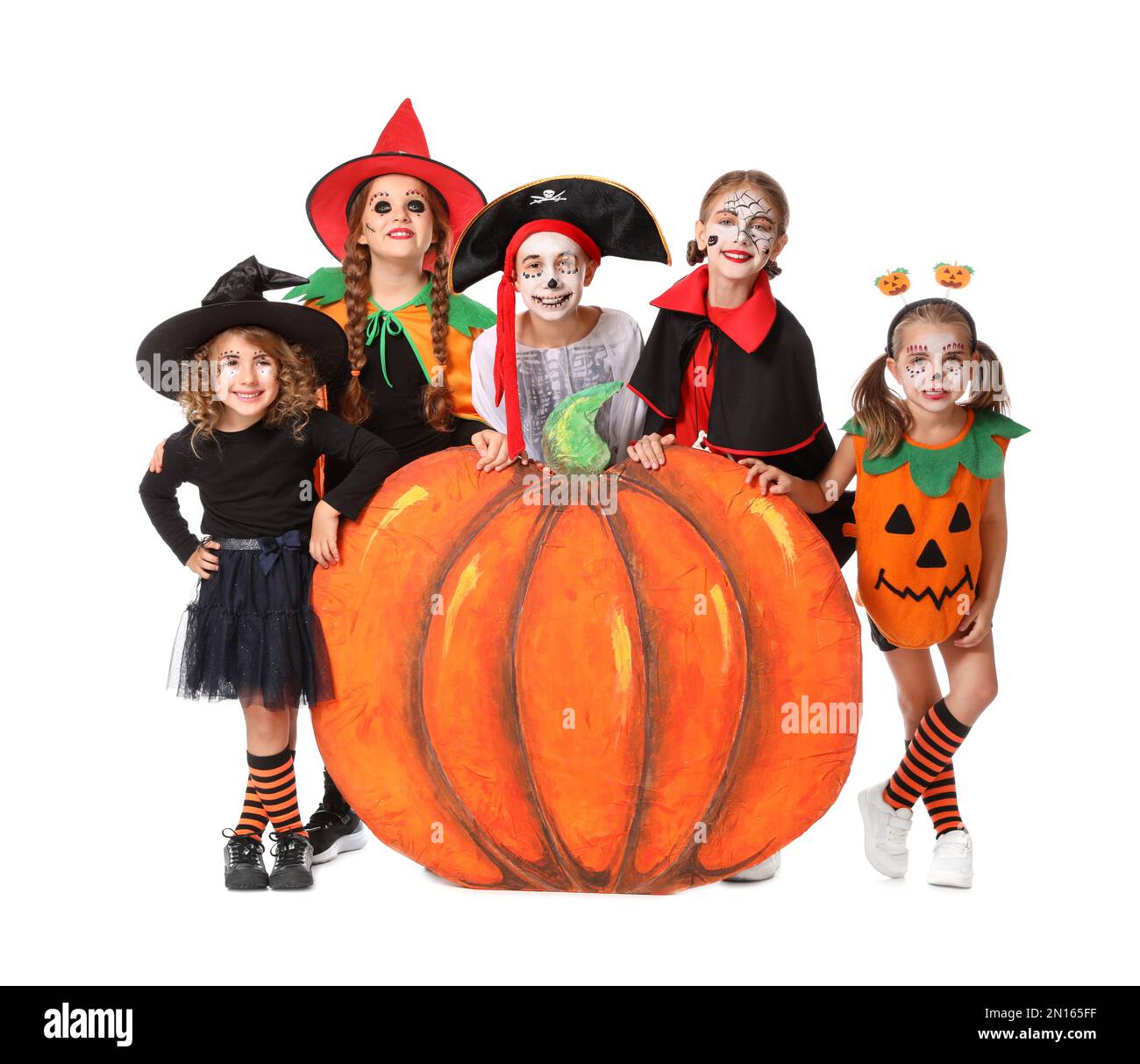 Cute little kids with decorative pumpkin wearing Halloween costumes on ...