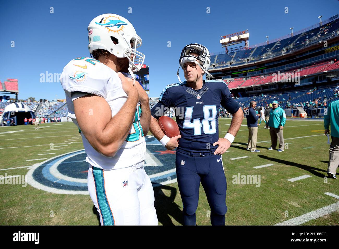 Miami Dolphins long snapper John Denney, left, talks with Tennessee ...