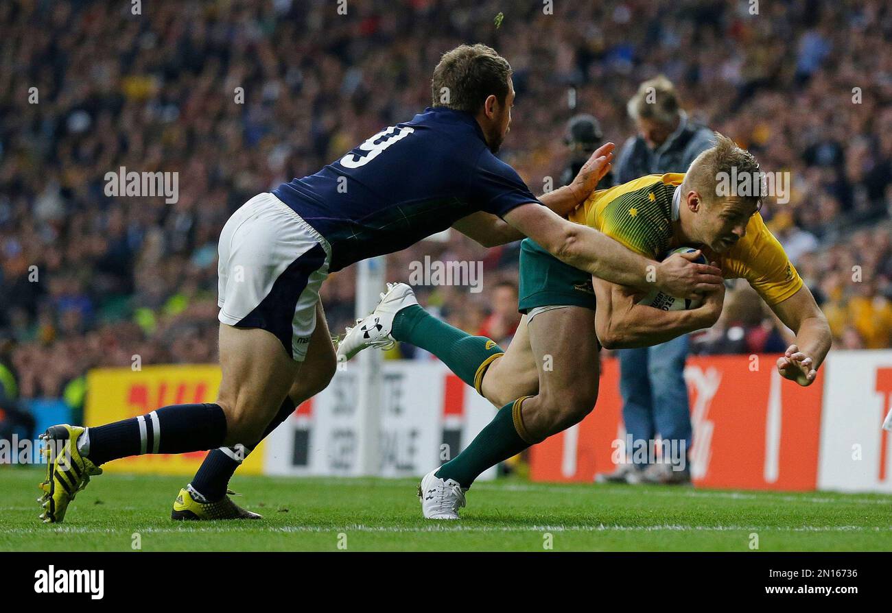 Australia's Drew Mitchell scores a try despite the challenge of ...