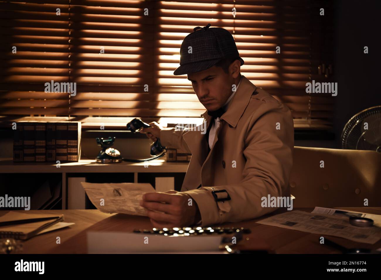 Old fashioned detective working at table in office Stock Photo - Alamy