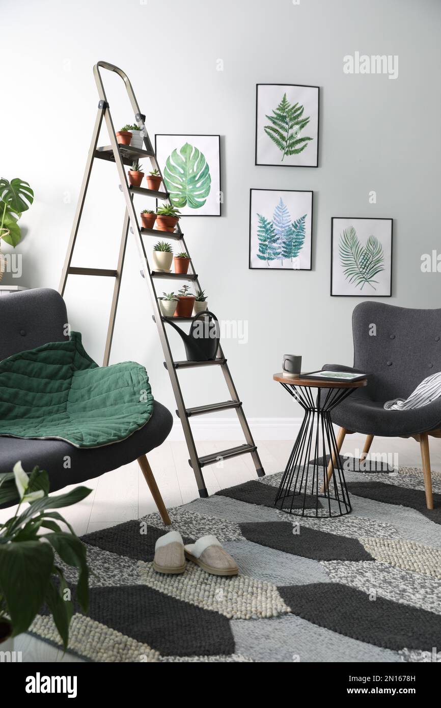 Stylish living room interior with decorative ladder Stock Photo - Alamy