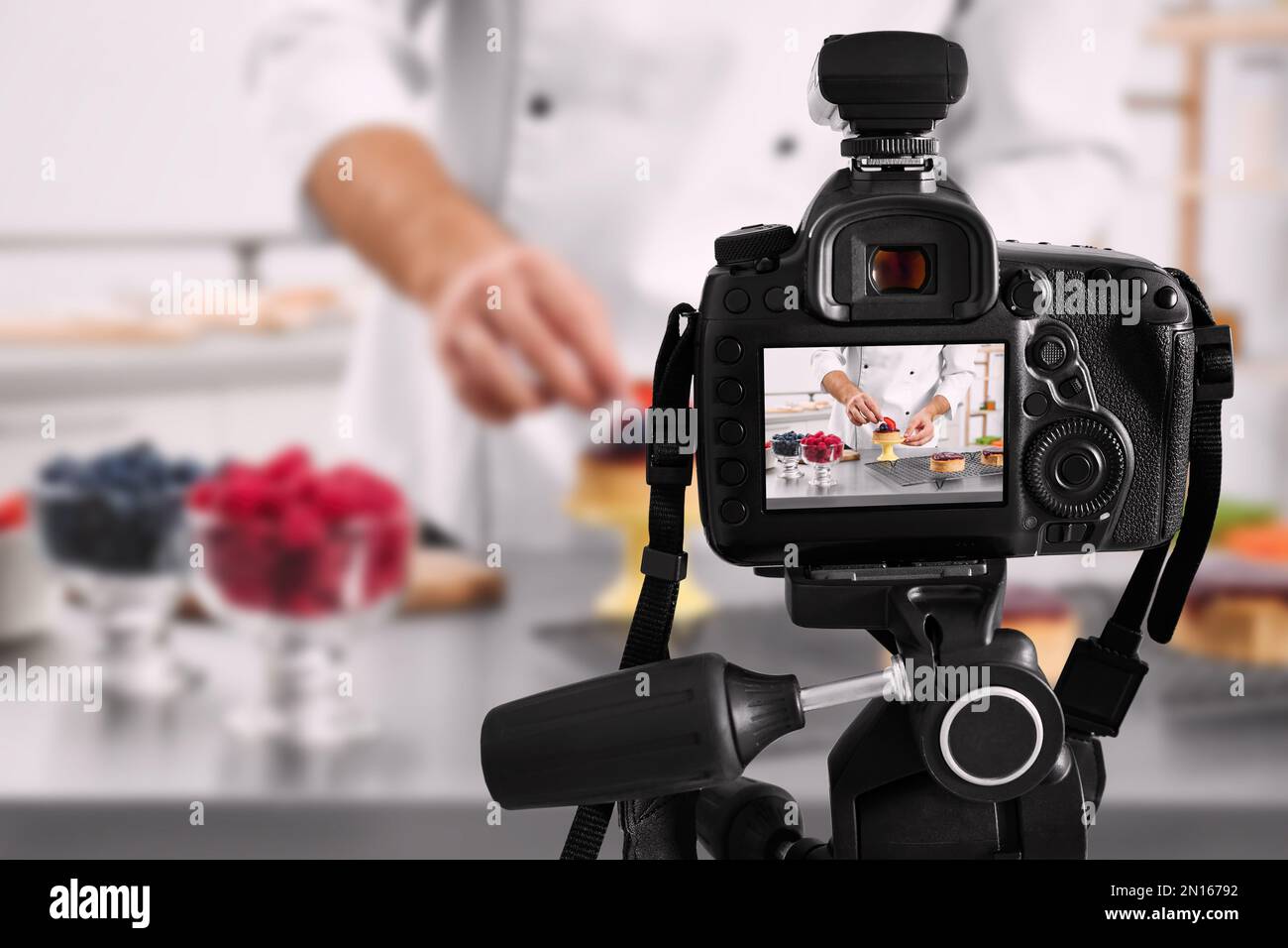 Food photography. Shooting of chef decorating dessert, focus on camera ...