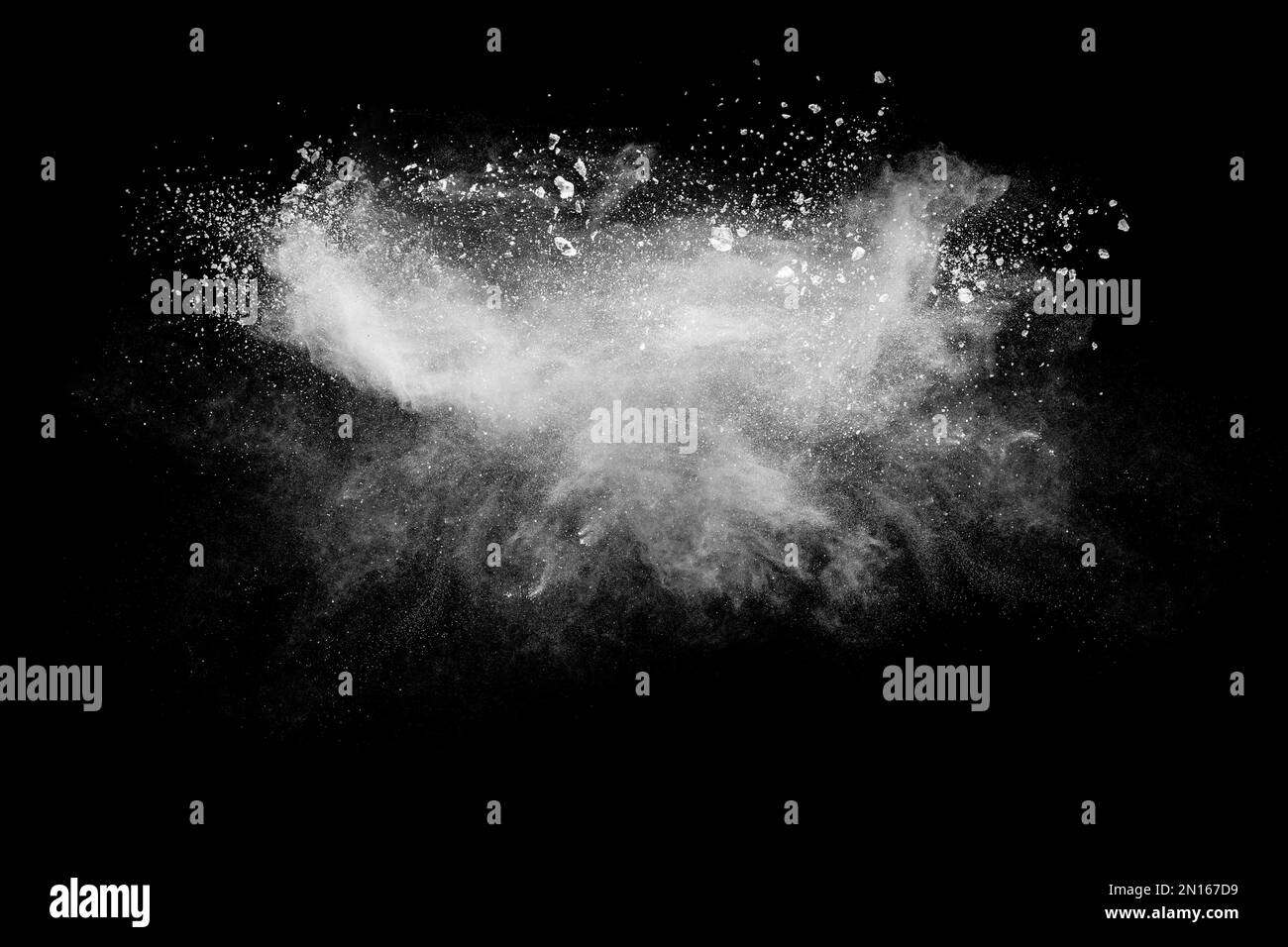 White powder explosion cloud against black background. White dust ...