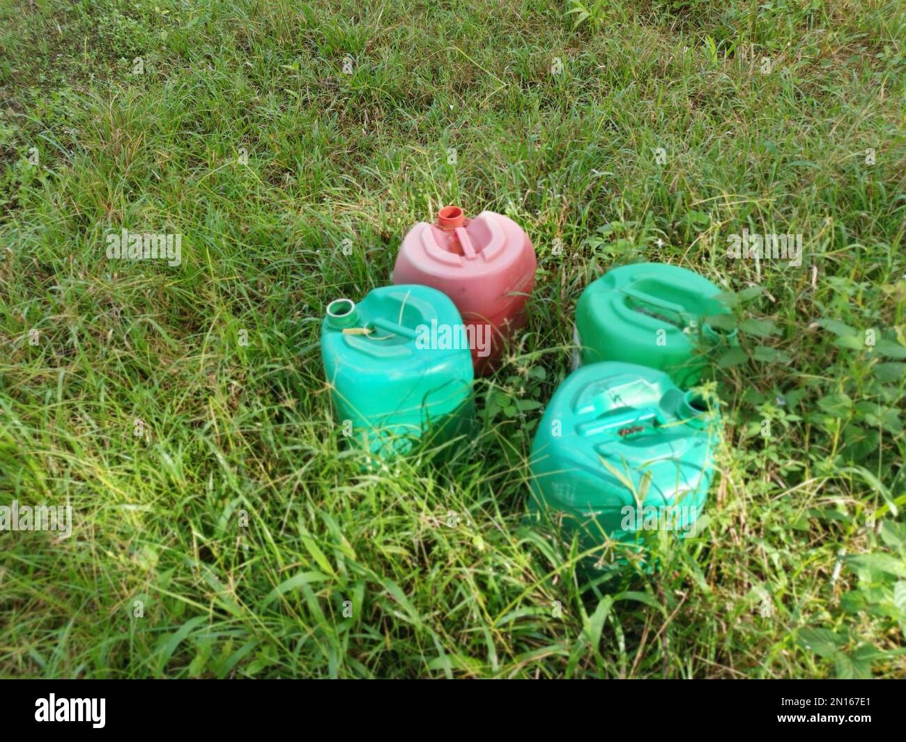 colorful pesticide containers left at the oil palm plantation Stock ...