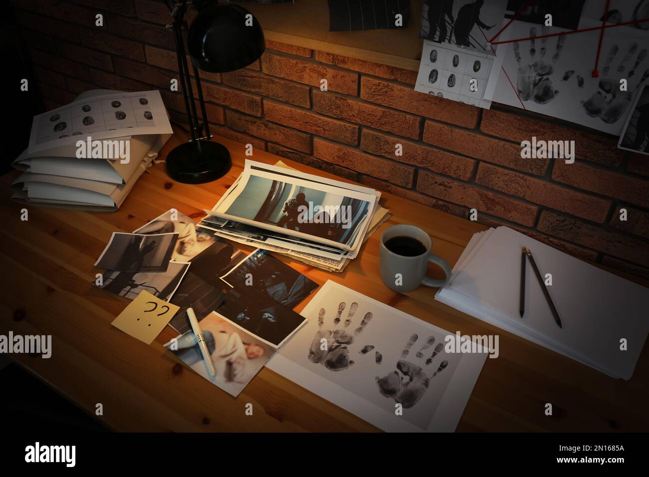 Detective workplace near brick wall in office Stock Photo - Alamy