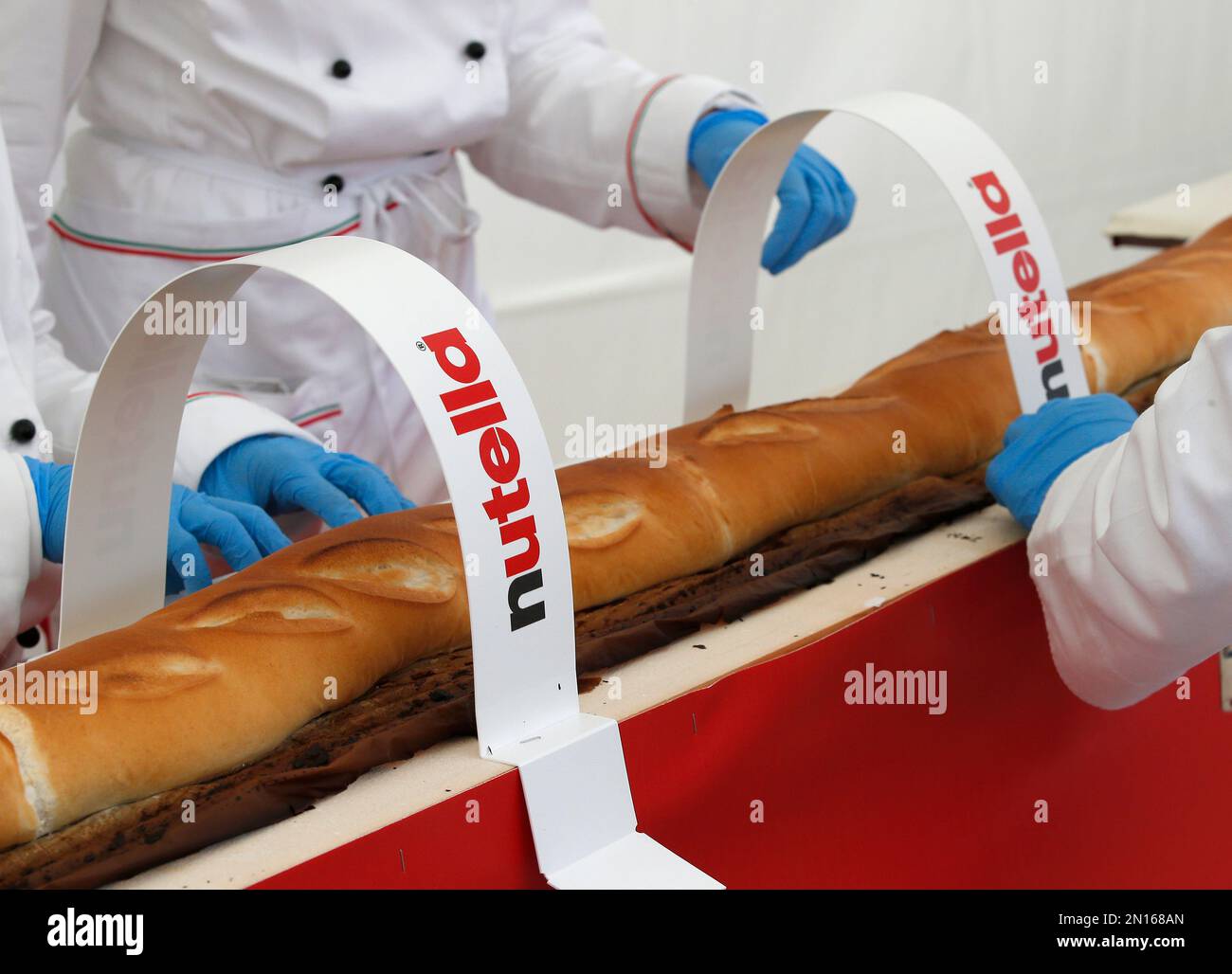 Bakers smear a record long baguette with Nutella at the Expo 2015 world ...