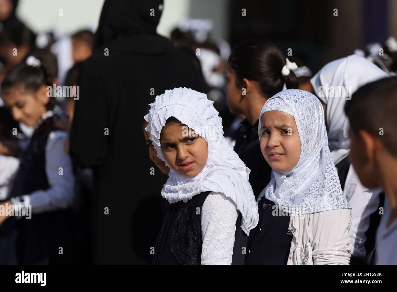 Iraqi students line up in their new school uniforms on the first day of ...