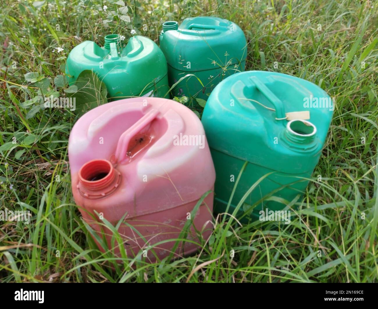 colorful pesticide containers left at the oil palm plantation Stock ...