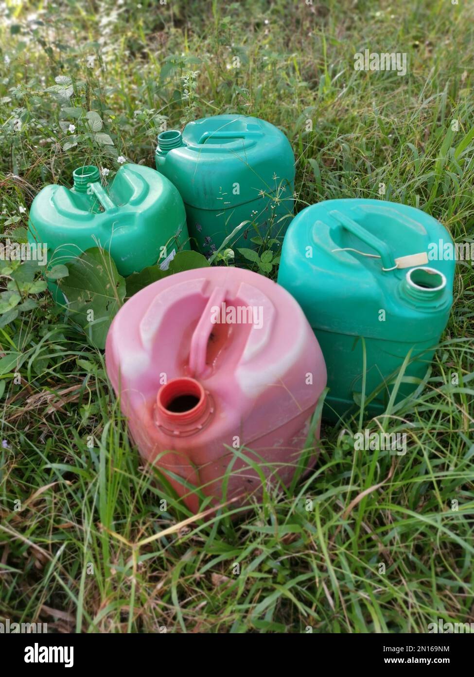 colorful pesticide containers left at the oil palm plantation Stock ...